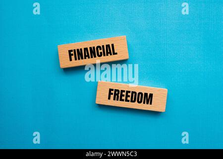 Financial freedom words written on torn paper piece with blue ...