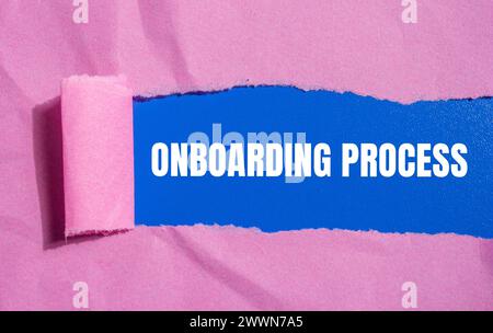 Onboarding process words written on torn cardboard paper with red ...
