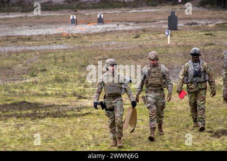 Sgt. Edgardo Suarez, assigned to 42nd Military Police Brigade, loads a ...