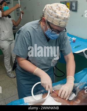 Capt. Jamie Fitch, a general surgeon, shows Sailors from Expeditionary ...