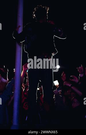 Kyle Harvey, a musical artist and rapper, invites attendees on stage ...