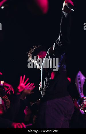Kyle Harvey, a musical artist and rapper, invites attendees on stage ...