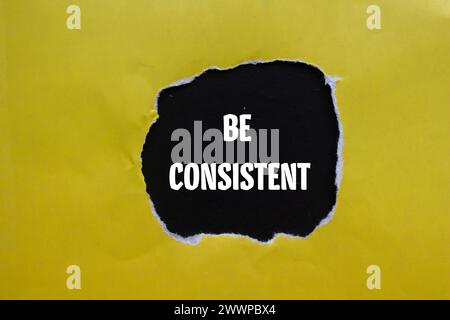 Be consistent words written on torn paper with blue background ...