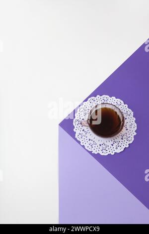 a violet cube made with colored paper to create a 3D optical illusion ...