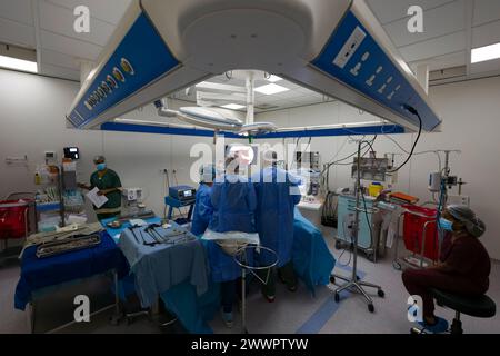 Surgeons and technicians conduct laparoscopic surgery inside a newly ...