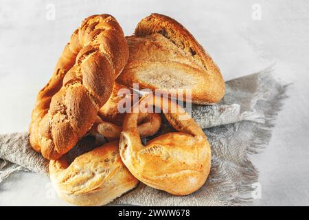 Assortment of bakery products. Challah, braided bread ring, kalachi ...