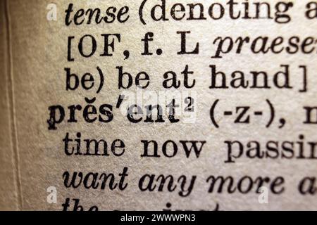 Word present on dictionary page, macro close-up Stock Photo - Alamy