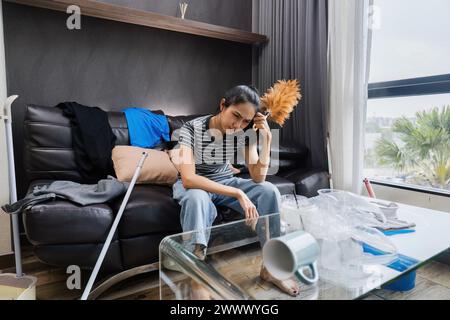 Shocked woman with messing home while cleaning house. Young girl ...