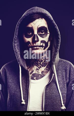 Portrait of woman with halloween skeleton makeup holding pumpkin and ...