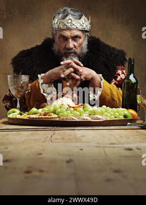 King, feast and drink wine in table as royalty on dining hall for ...