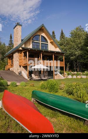 Handcrafted two story spruce log home cabin with fieldstone chimney ...