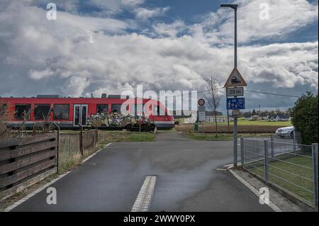Suburban railway crossing an ungated level crossing in a village, Forth ...
