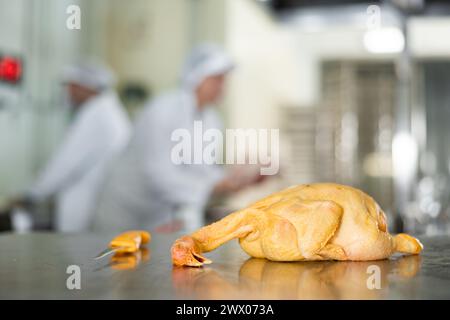 Raw dressed chicken lying on cutting table of butchers shop Stock Photo ...
