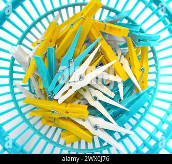 plastic basket full of colorful clothespins Stock Photo - Alamy