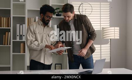 Businessmen work with financial papers, solve and discuss problems in ...