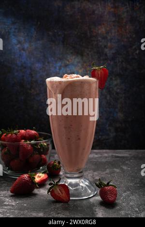 Strawberry milkshake on cement table with dark background. Strawberry ...