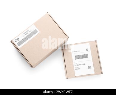 Cardboard packages with shipping labels and barcodes on white ...