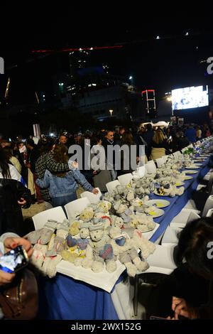 An installation of a Sabbath dinner table with chairs for the hostages ...