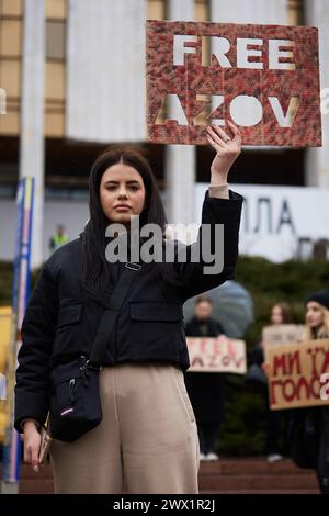 Ukrainian girl posing with a banner "Free Azov" on a public ...