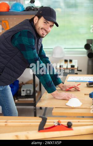 Carpenter working carefully looking at the plans work in carpentry. He ...