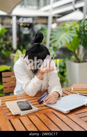 Worried woman having problems buying online with credit card and laptop ...