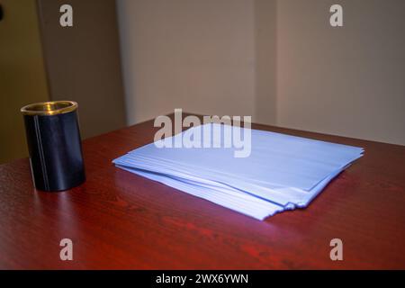 A pencil box and a bunch of A4 papers create an organized and ...