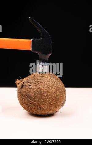 The process of breaking a coconut with a hammer. Ways to open a coconut ...