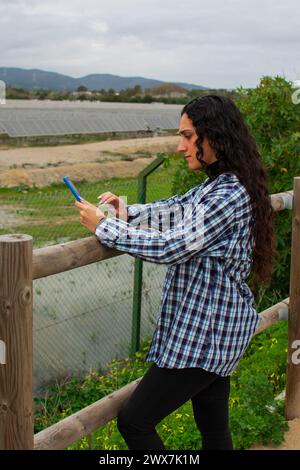 Technician checking the photovoltaic system on the roof of a house ...