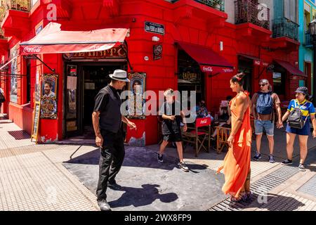 Two Tango Dancers Showing A Boy How To Dance The Tango Outside A Cafe ...