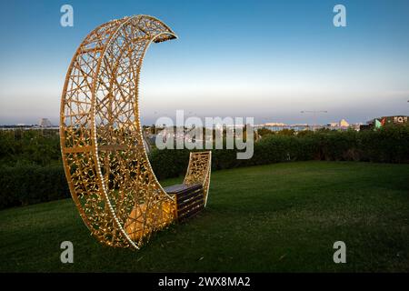 A crescent moon-shaped decorations with lights during Ramadan at Doha ...