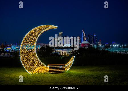 A crescent moon-shaped decorations with lights during Ramadan at Doha ...