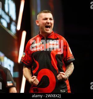 Nathan Aspinall celebrates winning against Michael van Gerwen during ...