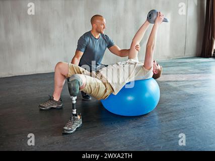 Physiotherapy, disability and patient with kettlebell or exercise ball ...