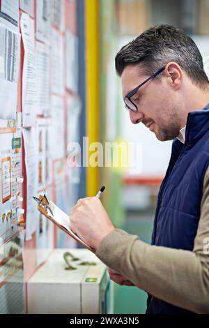 man holding clipboard with checklist employee workplace is reviewing ...