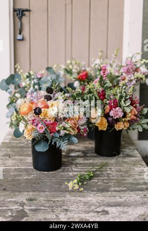 Chic floral shop display of seasonal flowers and eucalyptus in vases ...