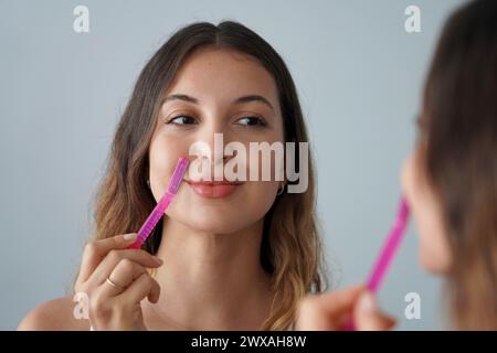 Facial hair removal. Dermaplaning. Close-up of beautiful teenager girl ...