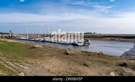 Wells, Norfolk, UK – March 25 2024. Boats in Wells harbour on the North ...