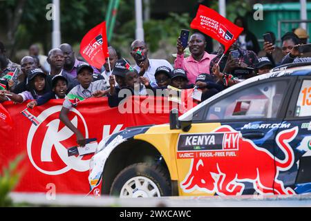 Kenyan and international fans cheer rally drivers during the official ...