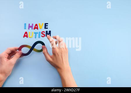 Autistic boy hands and rainbow eight infinity symbol. Autism awareness ...