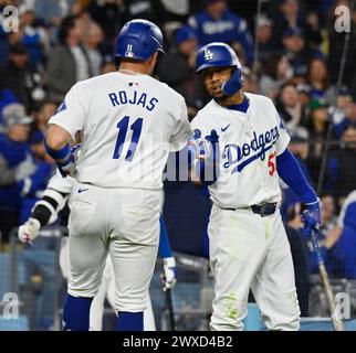 Los Angeles Dodgers shortstop Mookie Betts reaches for a small baseball ...