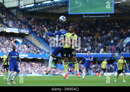 Malo Gusto of Chelsea wins a header against Wilson Isidor Of Sunderland ...