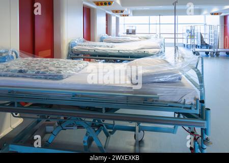 Clean hospital beds covered with film, ready for new patients. Hospital ...