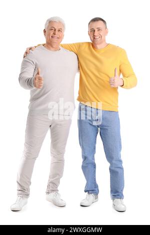 Mature brothers hugging on white background Stock Photo - Alamy