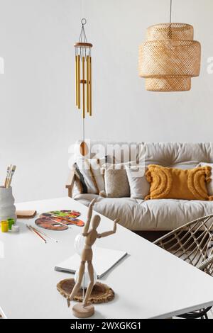 Interior of light room with wind chime and artist's workplace Stock ...