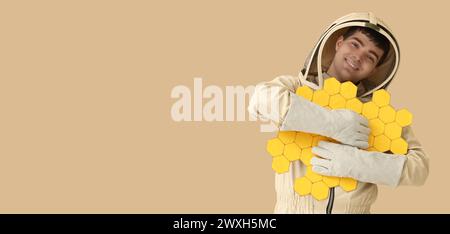 Male beekeeper hugging paper honeycombs on beige background Stock Photo ...