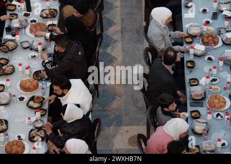 Aleppo, Syria. 30th Mar, 2024. People attend an iftar banquet at the ...