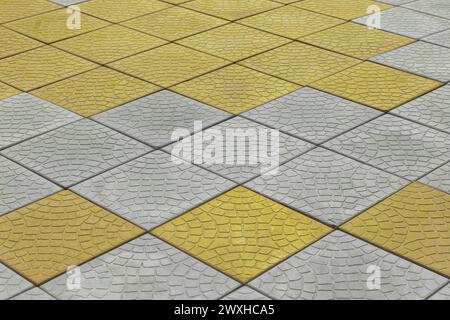 Diagonal pattern grey and yellow paving slabs floor road surface street ...