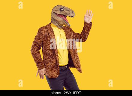 Eccentric funny showman in rubber dinosaur mask and velvet jacket ...
