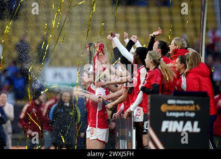 Arsenal's Kim Little and Leah Williamson lift the trophy with team ...
