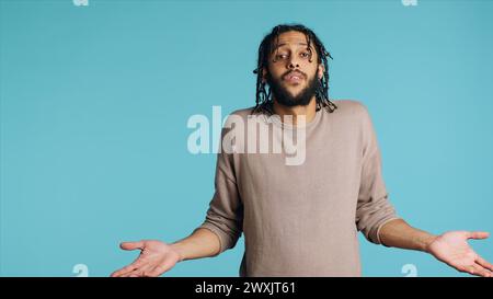 Uncaring Middle Eastern man shrugging shoulders, showing indifference ...